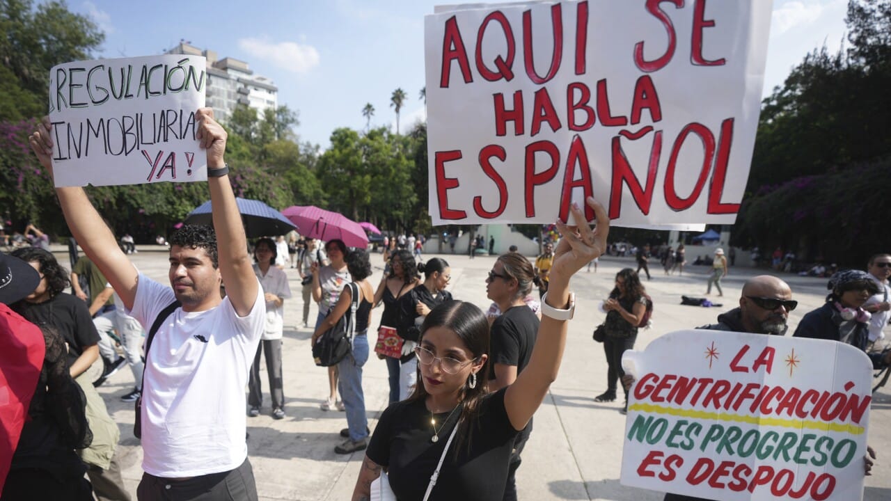 Anti-gentrification protestors in Mexico City hold signs demanding ...